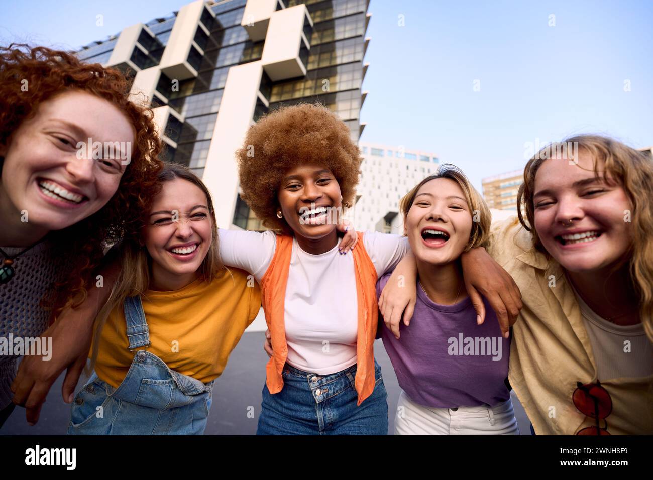 Multiracial happy friends posing for photo looking at cheerful camera ...