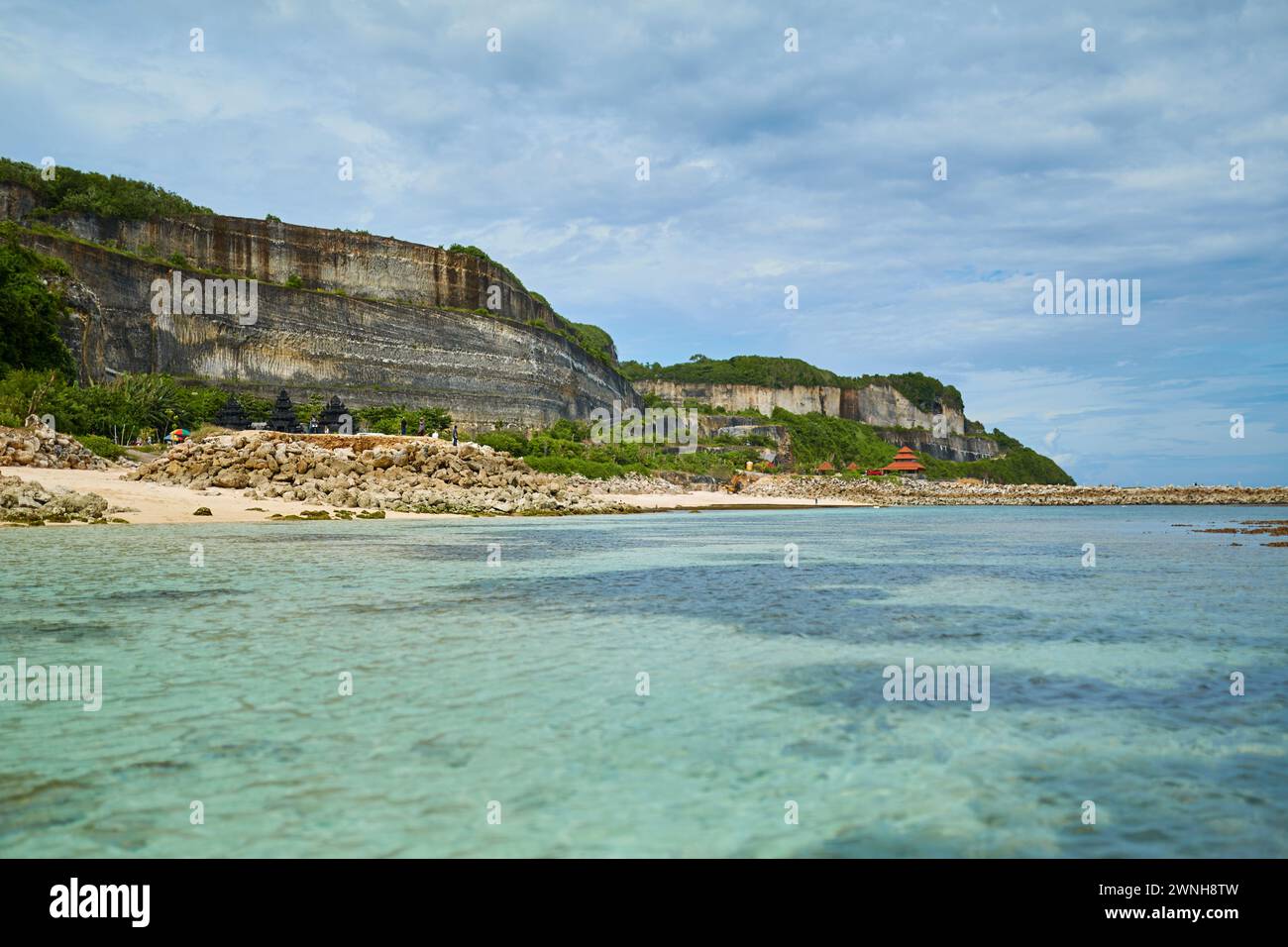 An incredibly beautiful deserted tropical beach under a cliff with ...