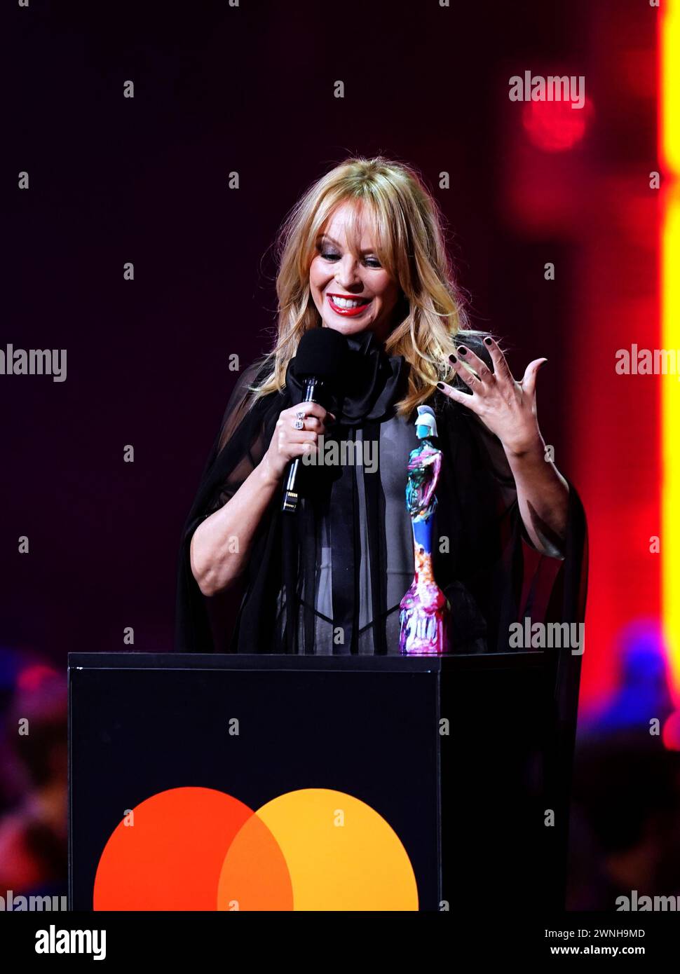 Kylie Minogue on stage after winning the Brits Global Icon award during ...