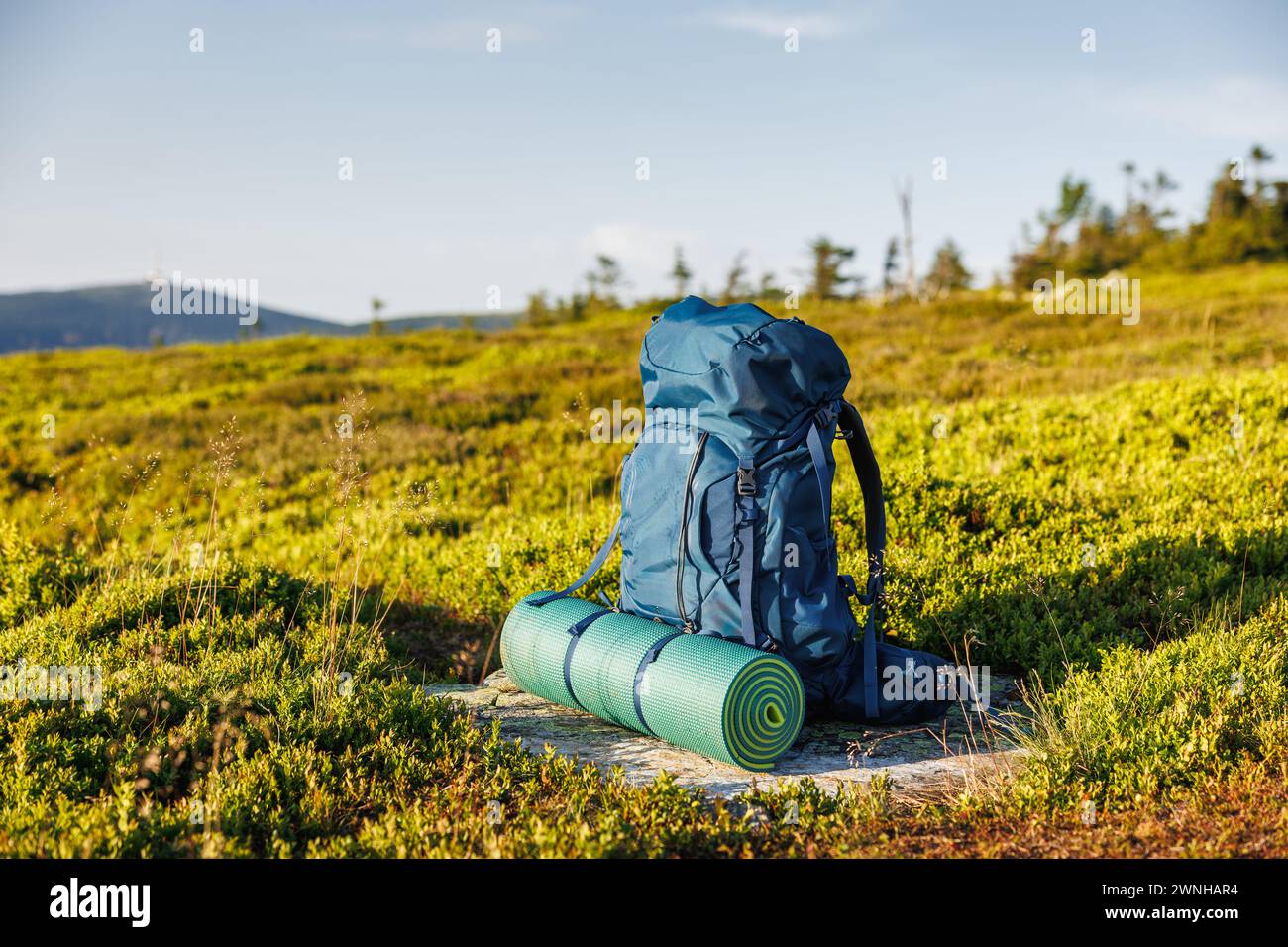 Hiking backpack with mat during trek in mountains. Camping and trekking ...