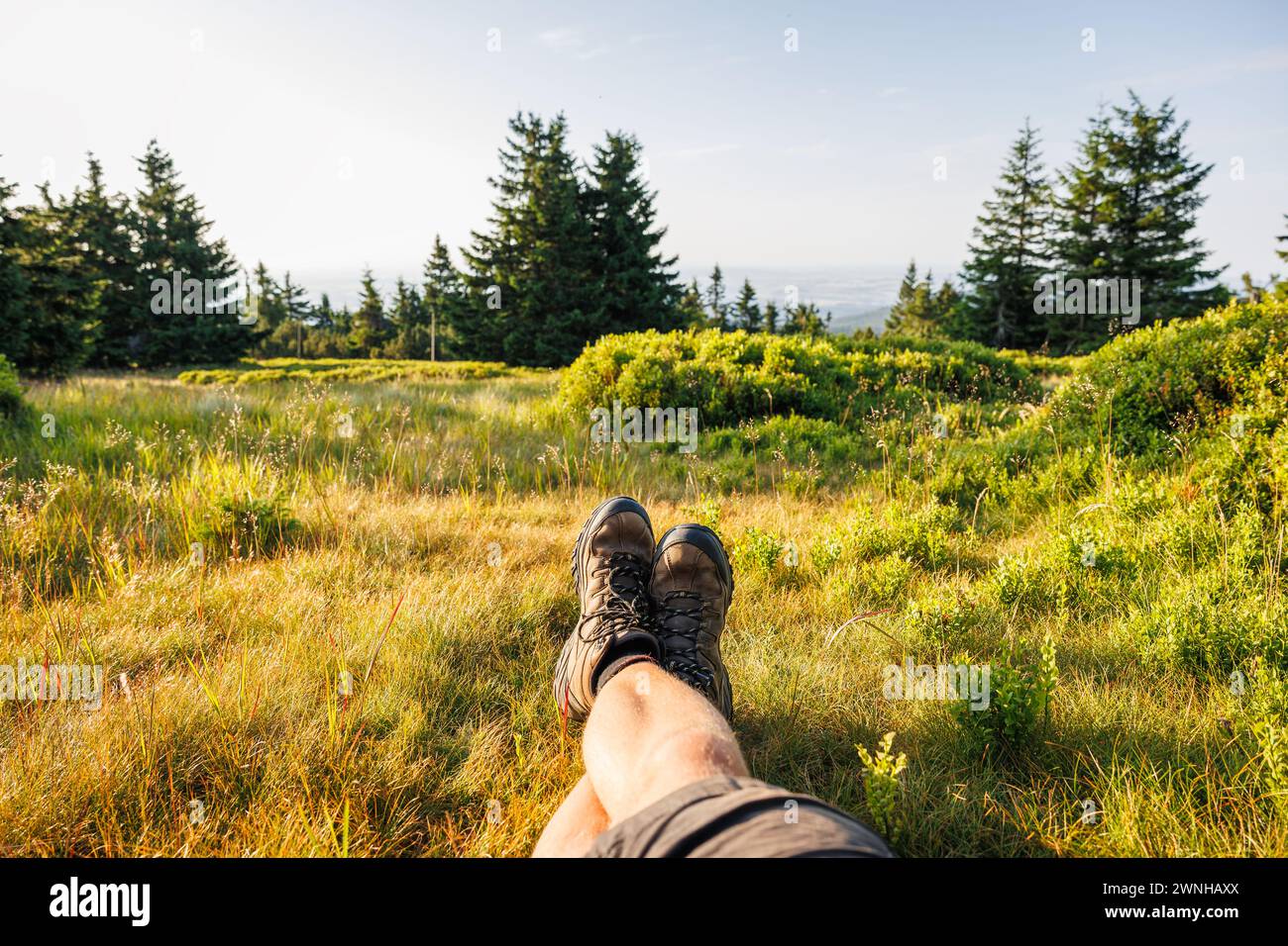 Crossed male legs with leather hiking boots. Relaxation in mountain ...