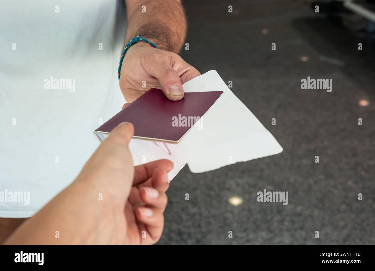 closeup hand of traveler showing passport and boarding pass at terminal ...