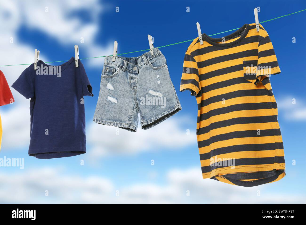 Different clothes drying on washing line against blue sky Stock Photo ...