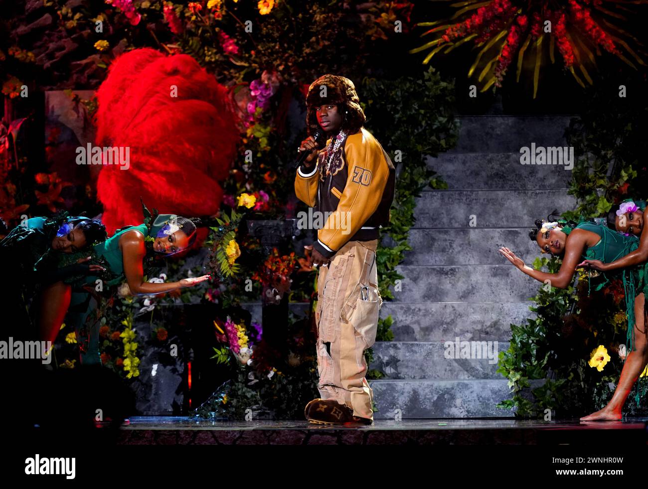 Rema performing on stage during the Brit Awards 2024 at the O2 Arena ...