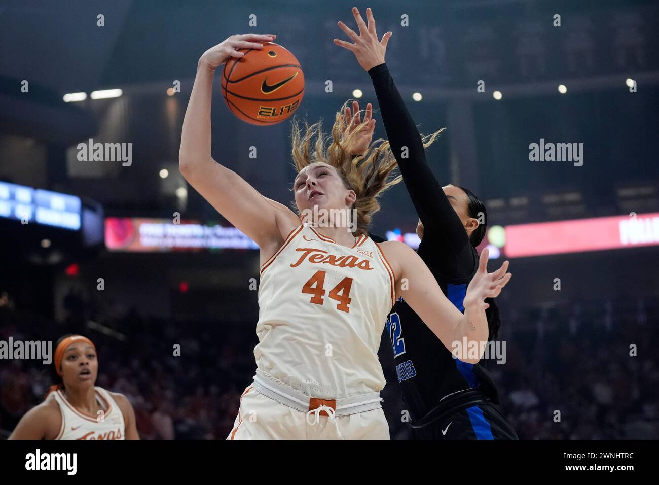 Texas forward Taylor Jones (44) grabs a rebound in front of BYU forward ...