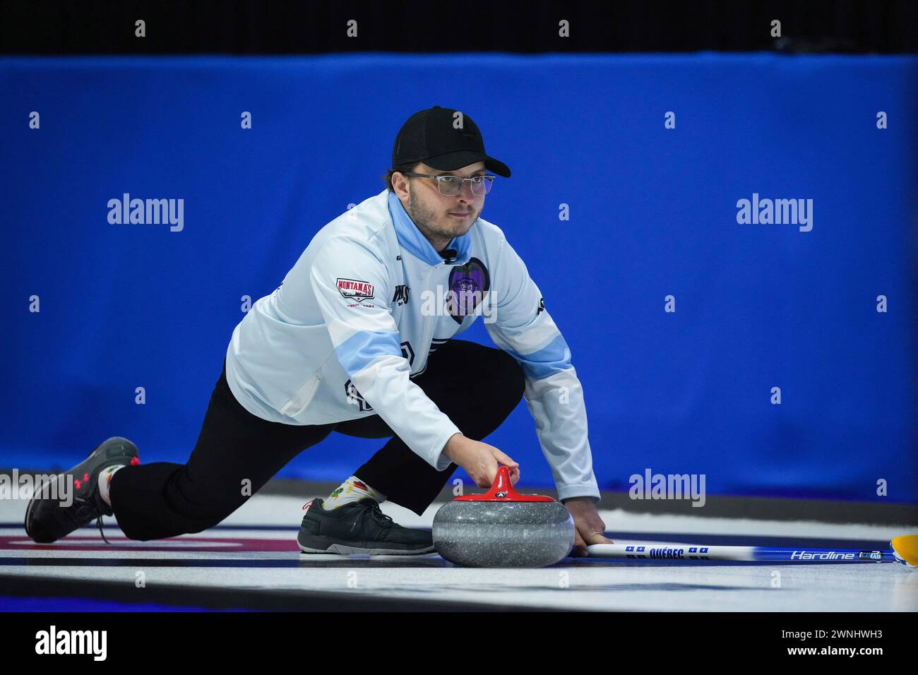 Quebec skip Julien Tremblay delivers a rock while playing against Nunavut at the Brier curling ...