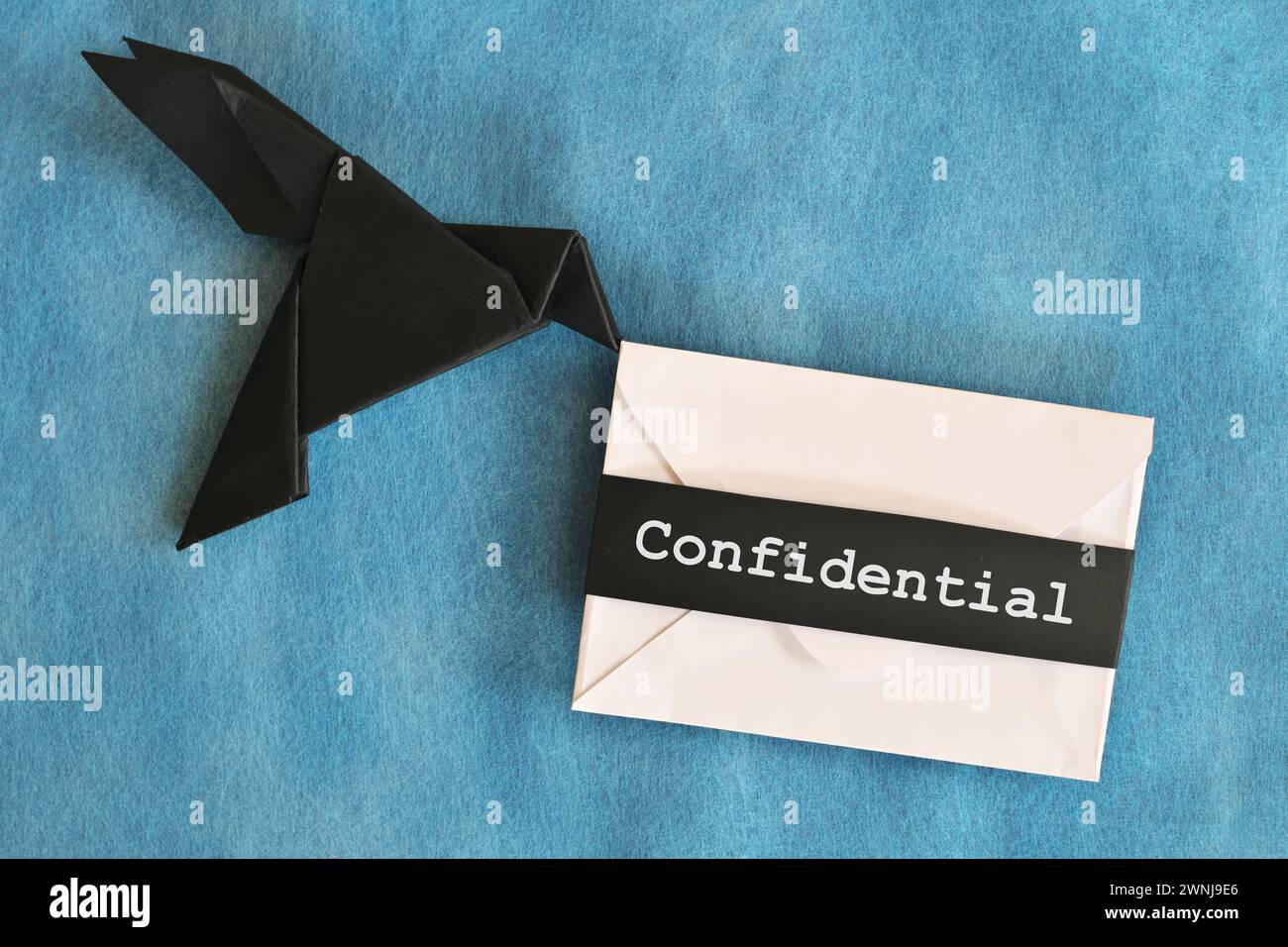 Black raven paper origami carrying white letter envelope with word ...