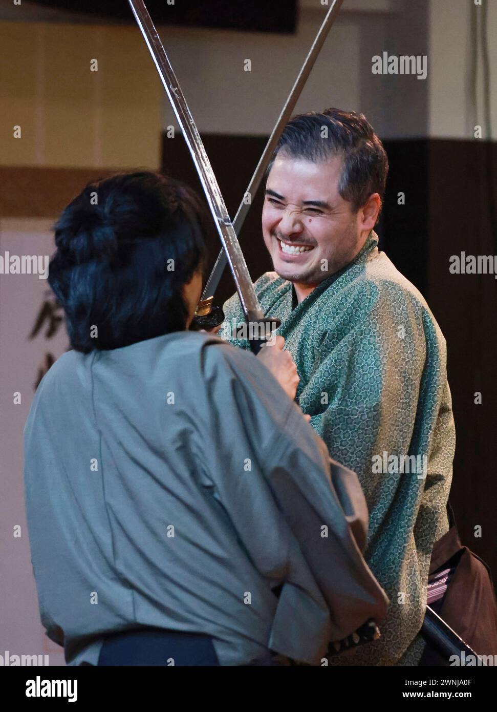 A foreign tourist competes with the enemy actor with swords during the ...