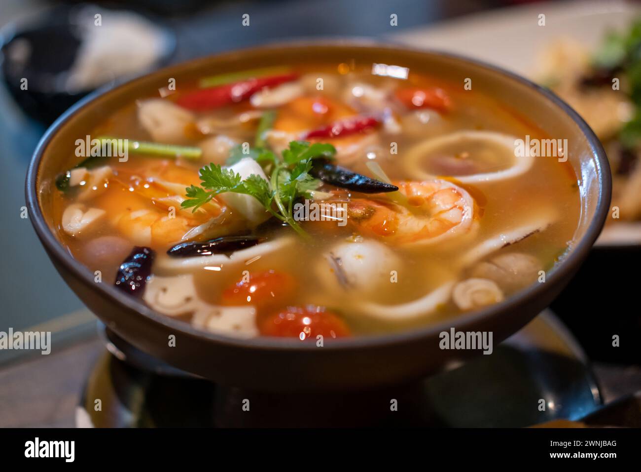 Tom yum, Thai Seafood spicy soup in bowl Stock Photo - Alamy