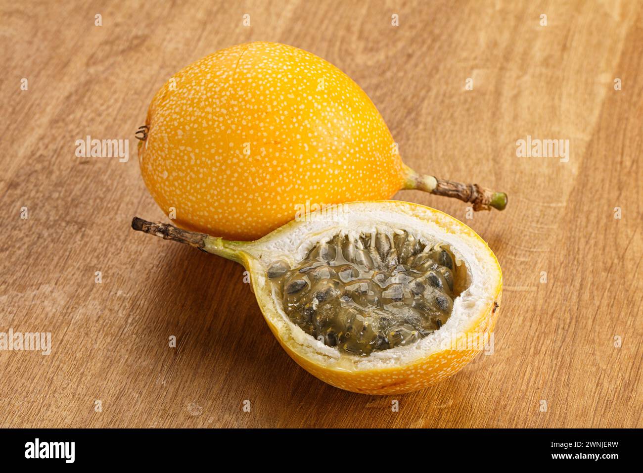 Yellow granadilla fruit with cut half Stock Photo - Alamy