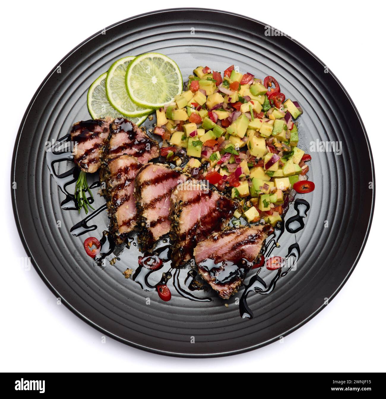 Sliced Organic grilled Tuna fillet covered with sesame seeds and salsa ...