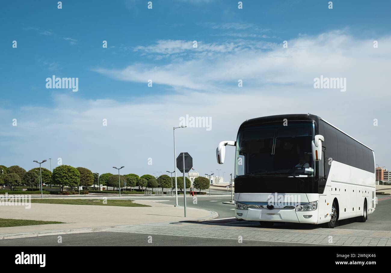 White Modern comfortable tourist bus driving through highway. Travel ...