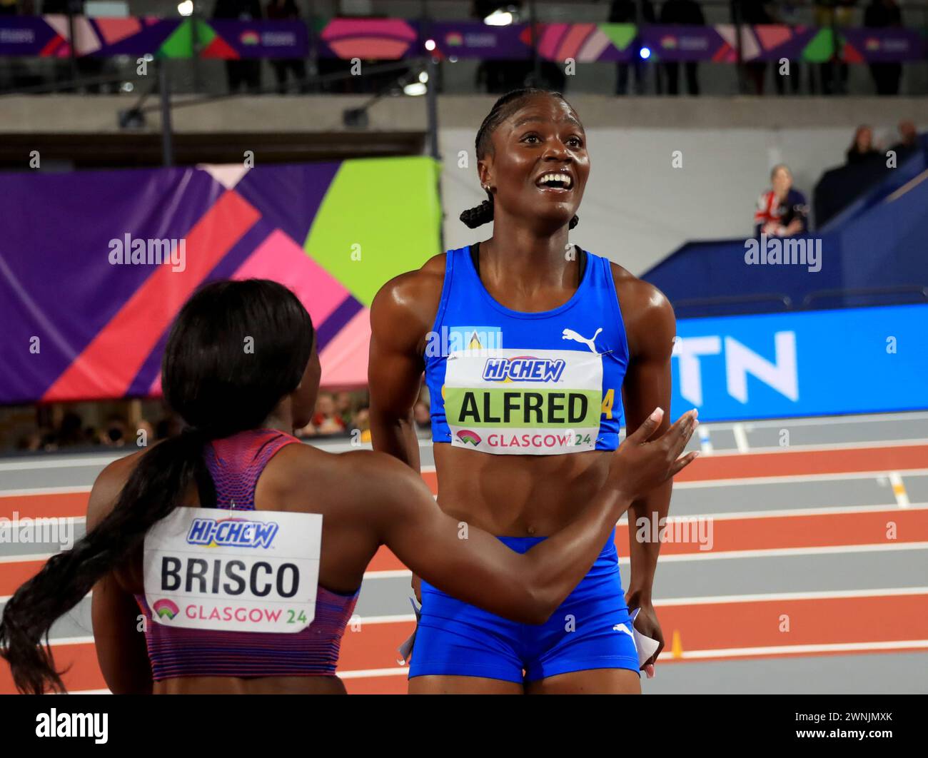 Glasgow, Britain. 2nd Mar, 2024. Julien Alfred (R) of Saint Lucia checks the final result after ...