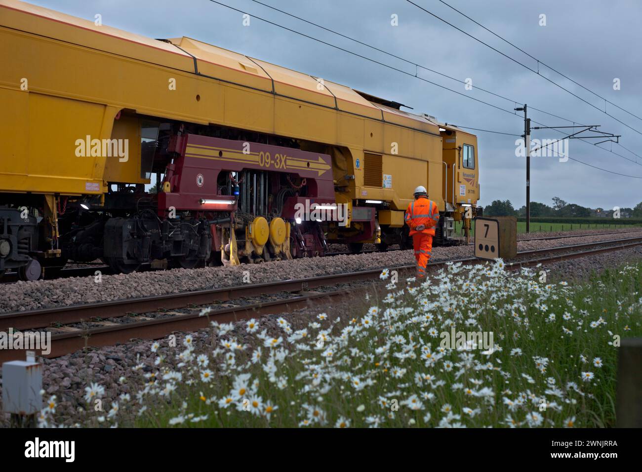 Railway tamping machine packing ballast under new track at Brock, north ...