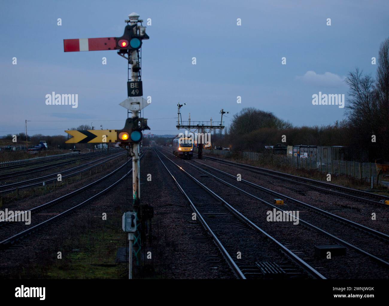 Semaphore distant and home railway signals with a approaching class 170 ...