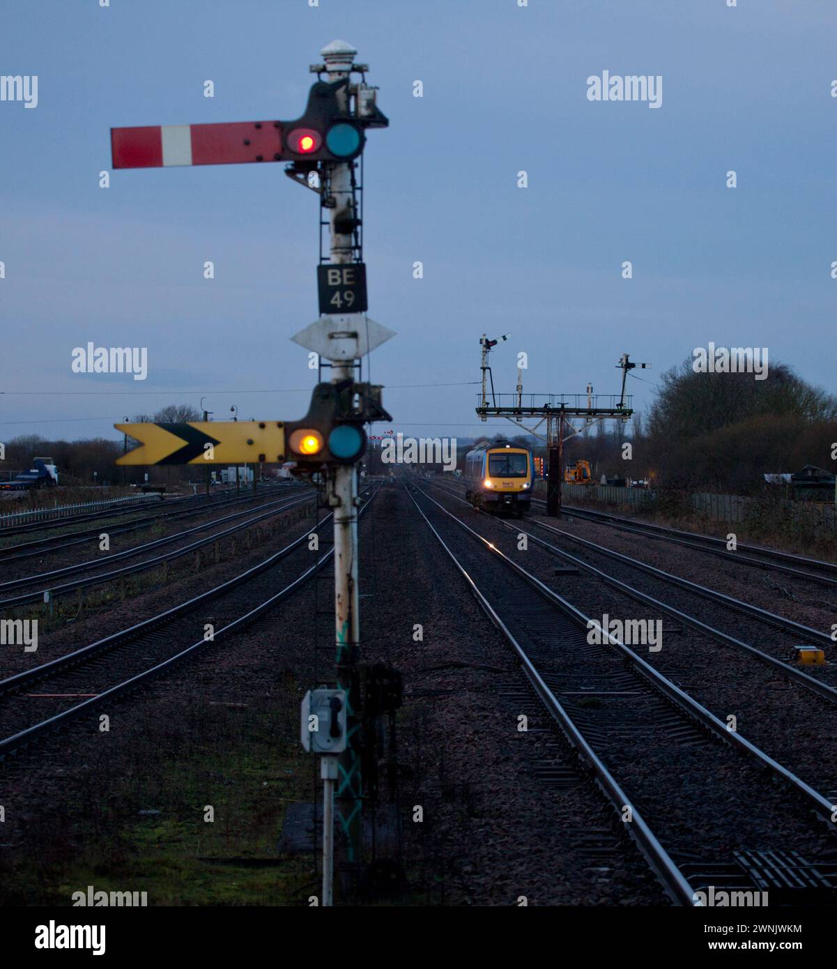 Semaphore distant and home railway signals with a approaching class 170 ...