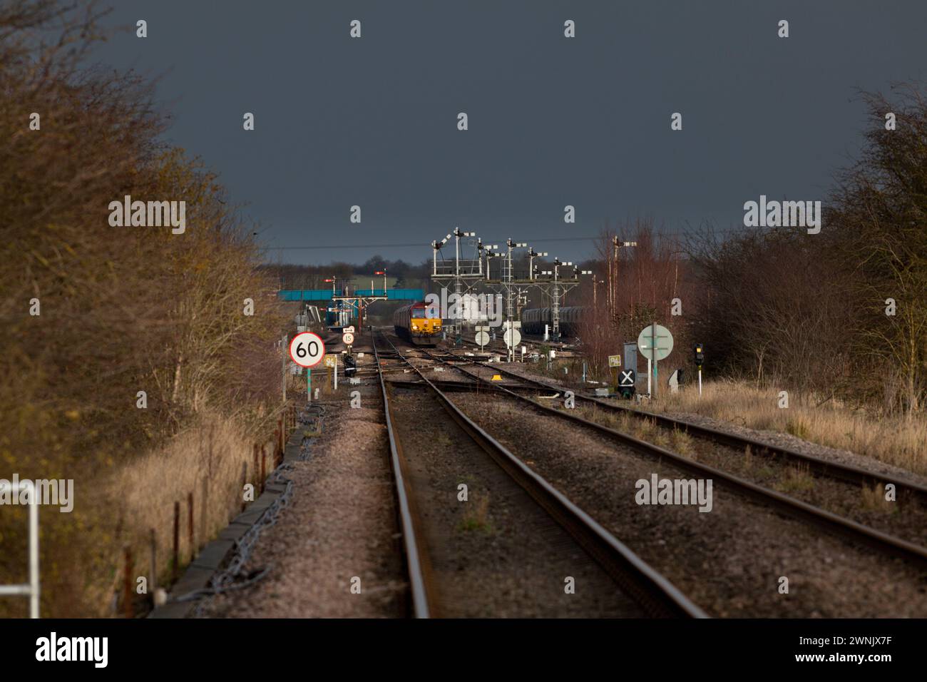 DB Cargo Rail UK class 66 locomotive hauling a freight train passing ...