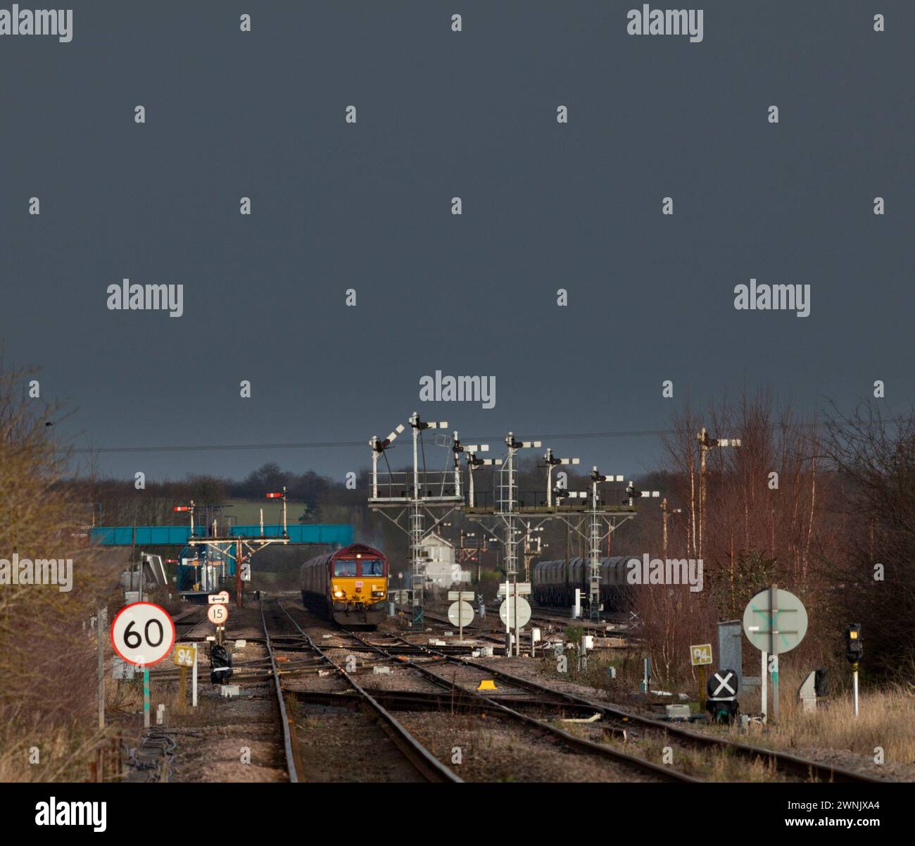 DB Cargo Rail UK class 66 locomotive hauling a freight train passing ...