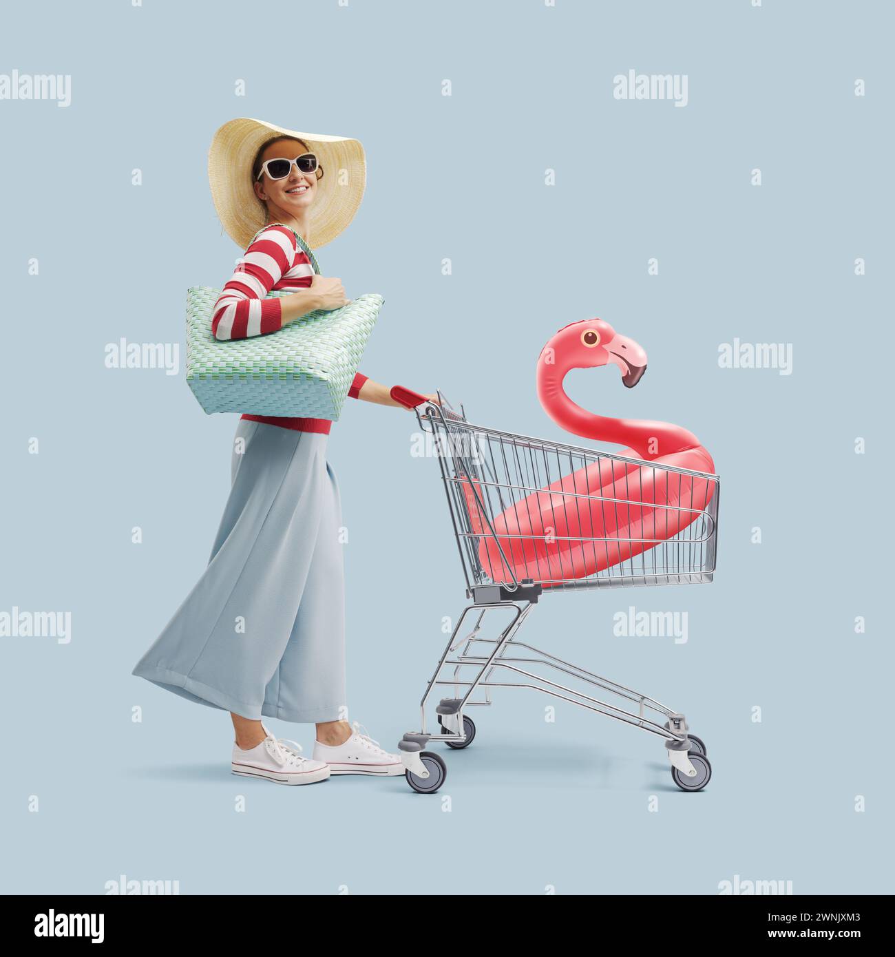 Fashionable young woman pushing a shopping cart, she is buying an ...