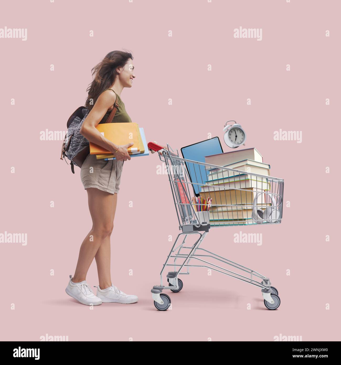 Happy female student pushing a shopping cart filled with books Stock ...