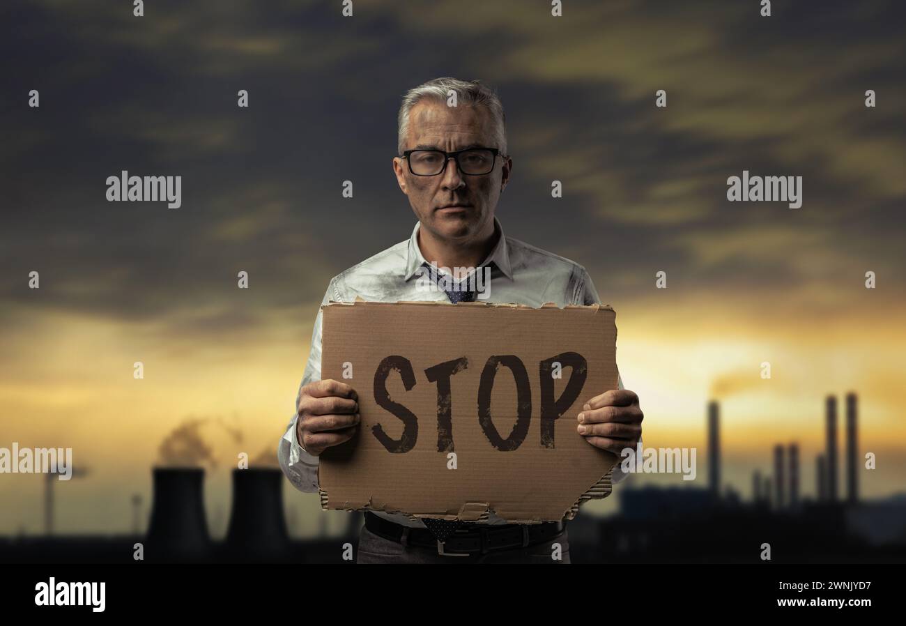 Dirty desperate businessman holding a sign and protesting against ...