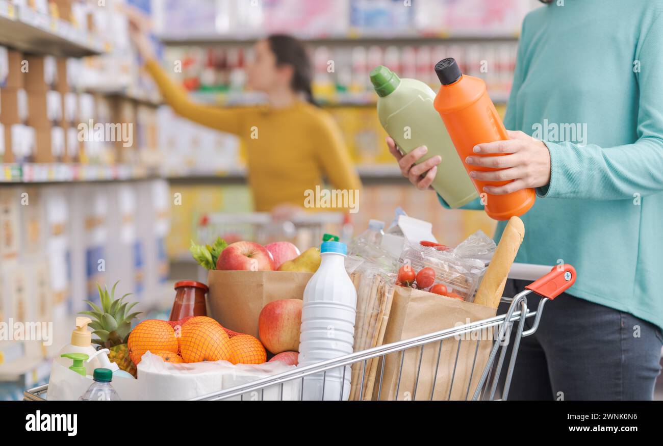 Woman comparing food brands hi-res stock photography and images - Alamy