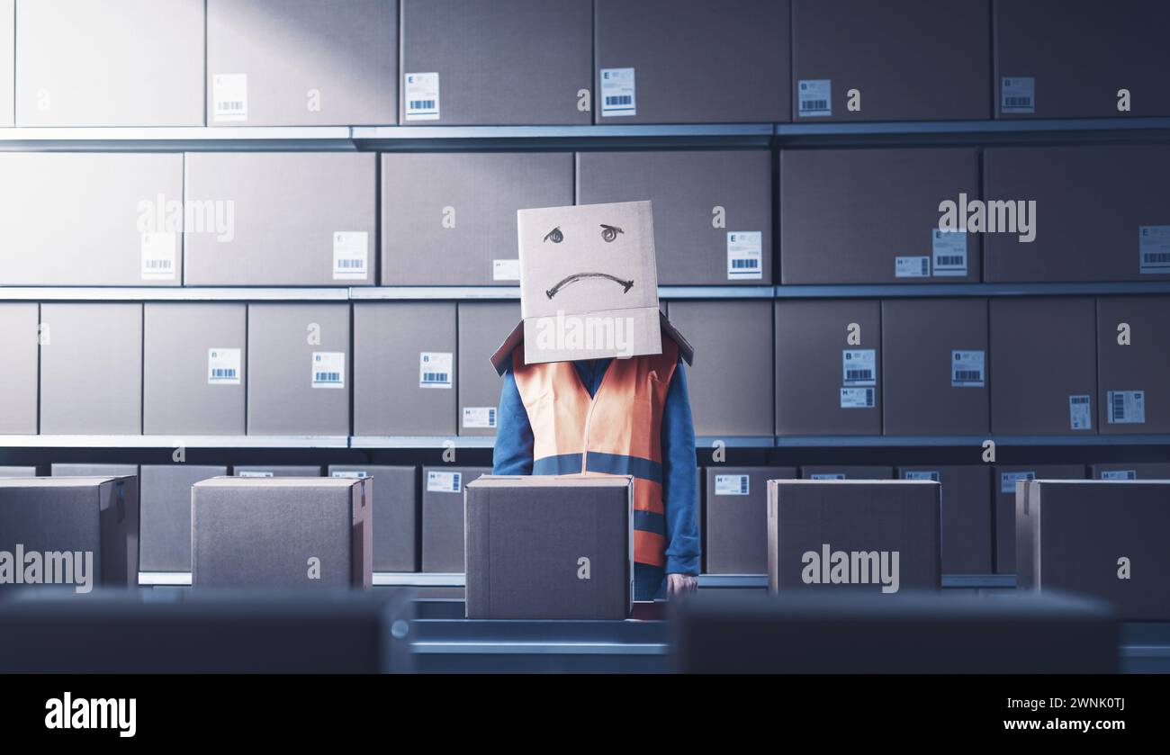 Frustrated depressed warehouse worker with a box on her head ...