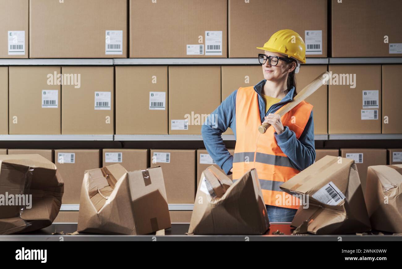 Confident smiling rebellious worker posing with a baseball bat at the ...