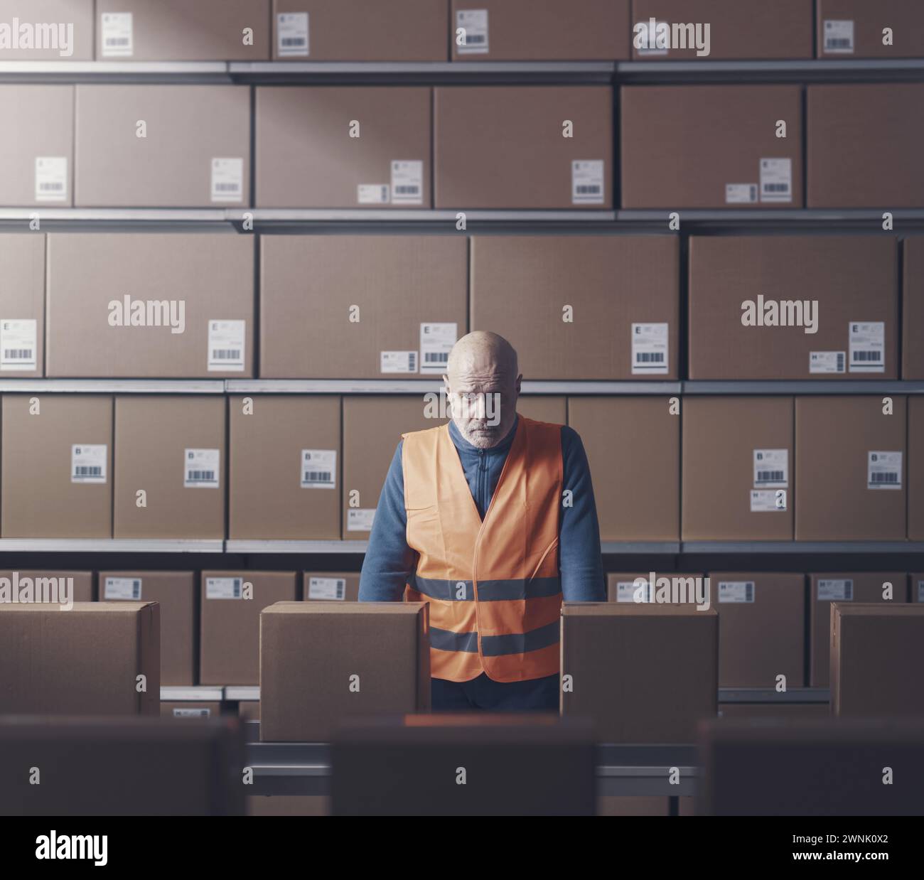 Sad frustrated warehouse worker checking boxes on the conveyor belt ...