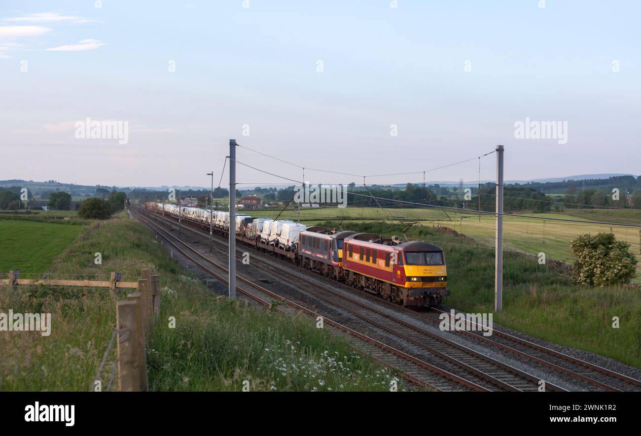 A DB Cargo freight train hauled by 2 class 90 electric locomotives ...