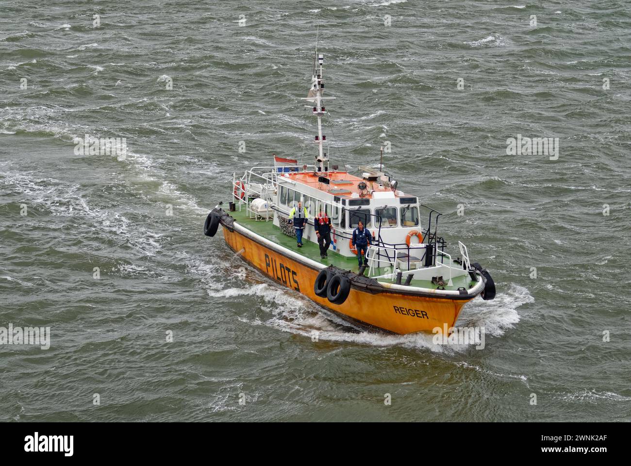 Crew members and the Pilot getting ready while a Dutch Pilot Boat ...
