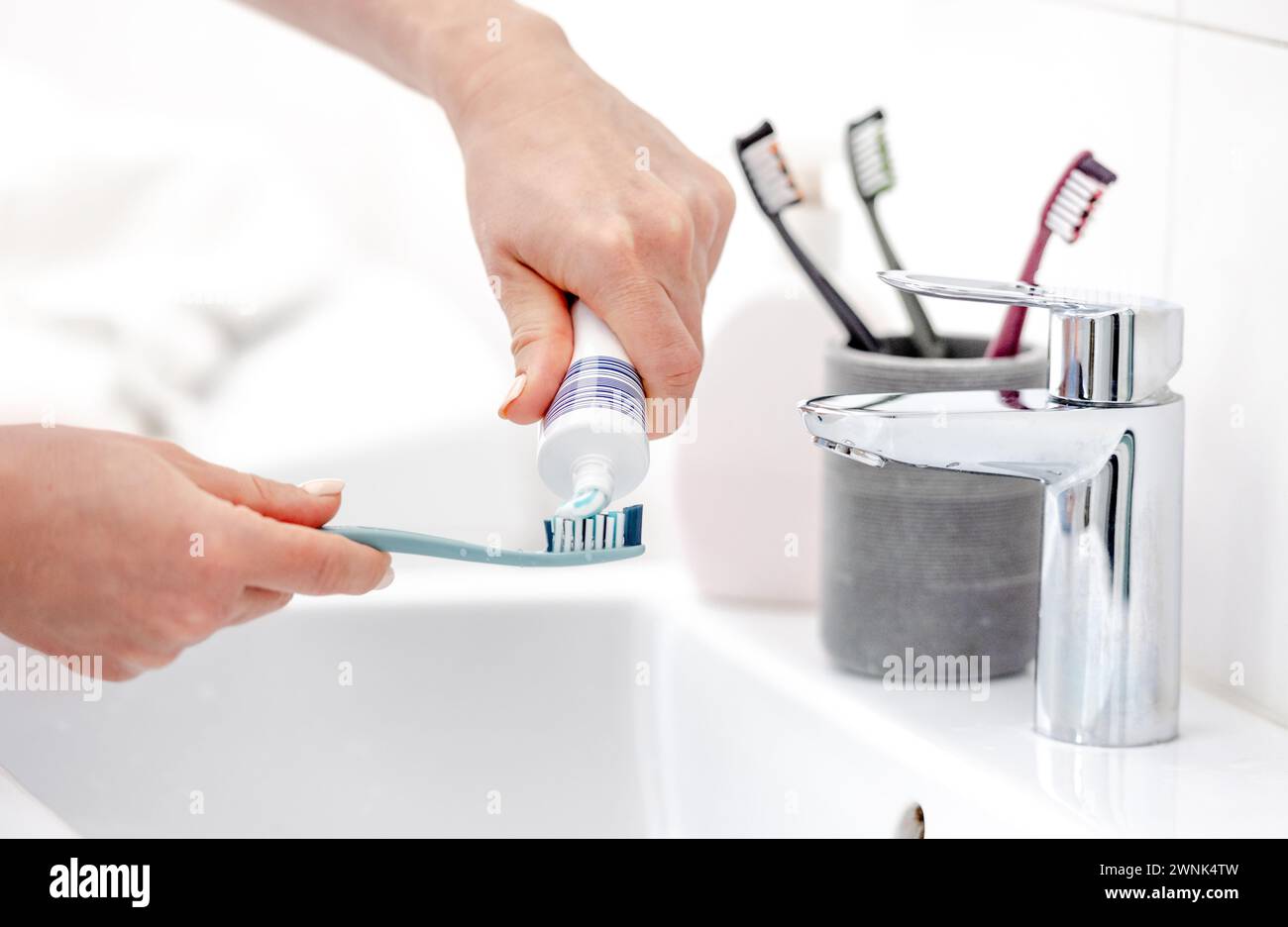 Girl'S Hand Applies Toothpaste On Brush For Hygiene In Pristine White ...