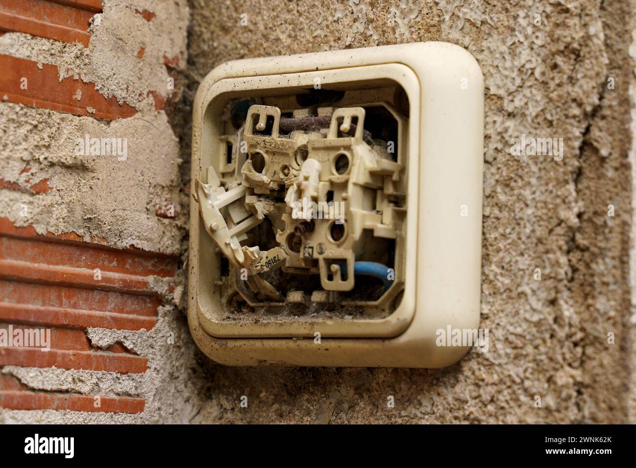 Detail view of a broken electrical switch mounted on a brick wall Stock ...