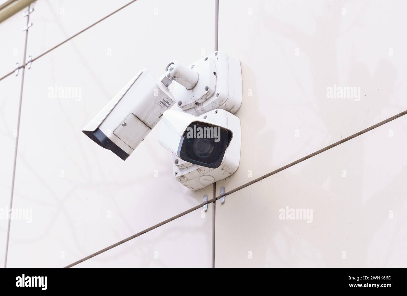 Two security cameras positioned back-to-back for surveillance mounted ...