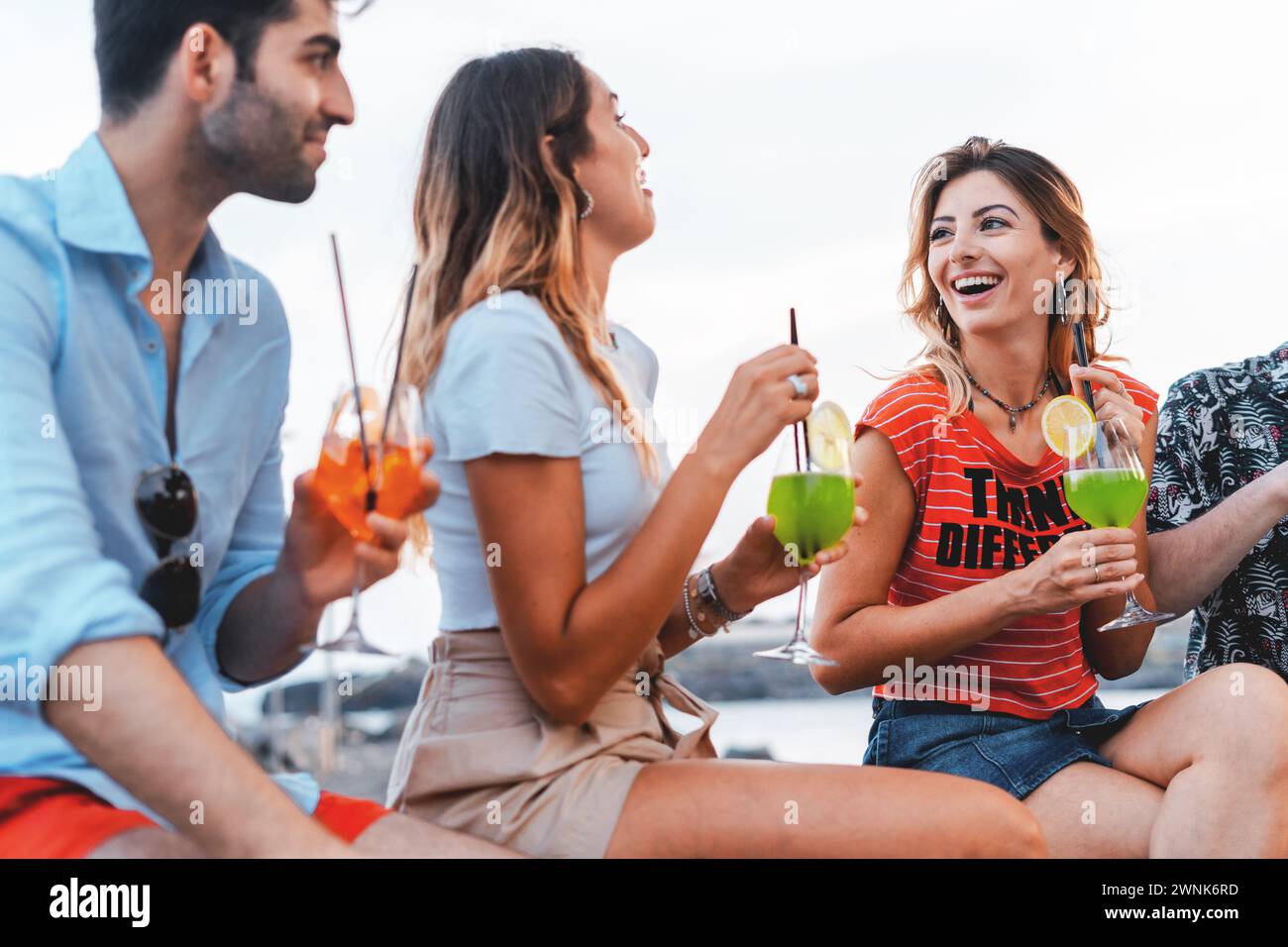 Friends share a joyful moment with cocktails - Laughter and bonding in ...