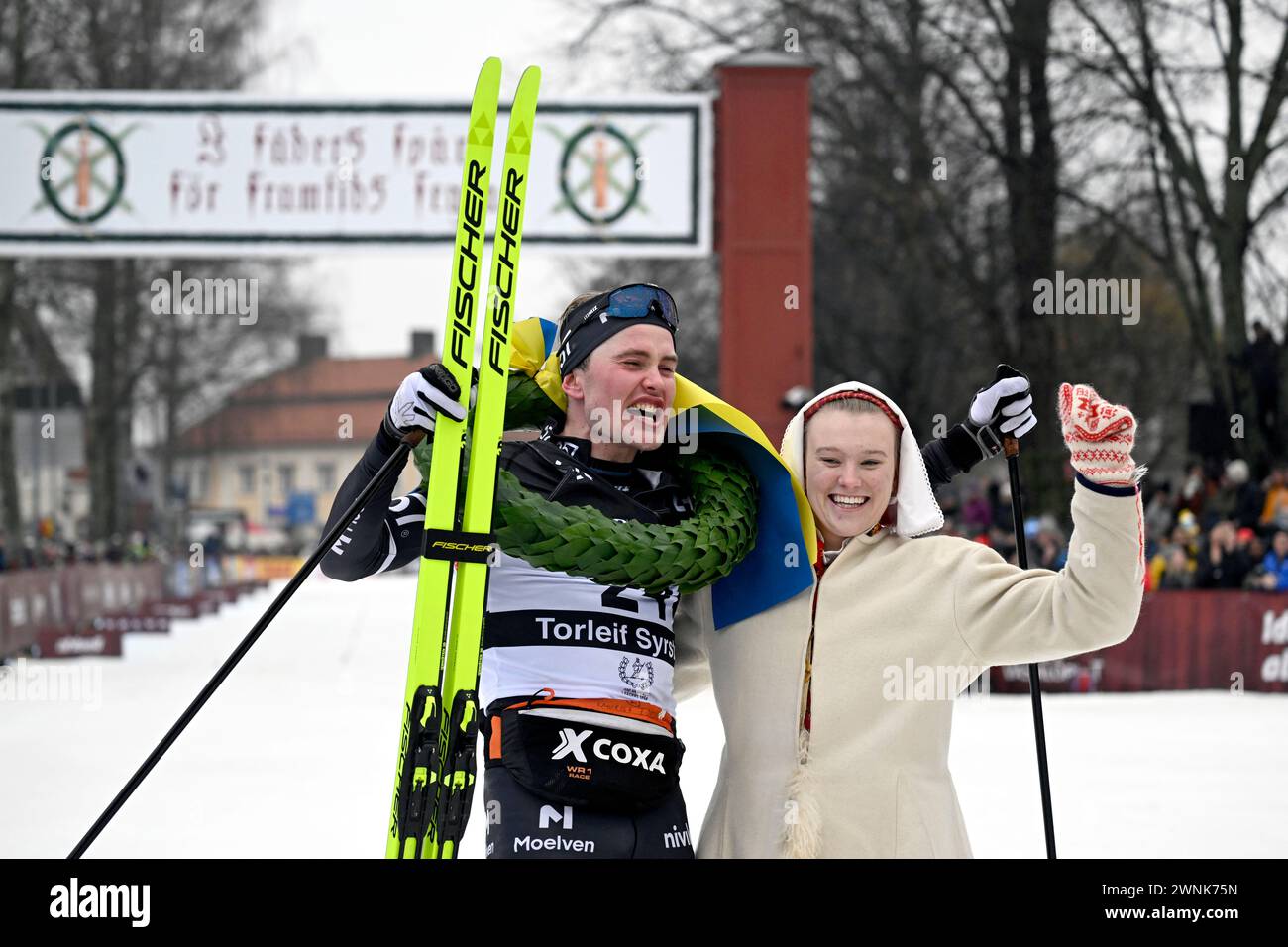 Torleif Syrstad, Norway, is congratulated by wreath-layer Elsa ...