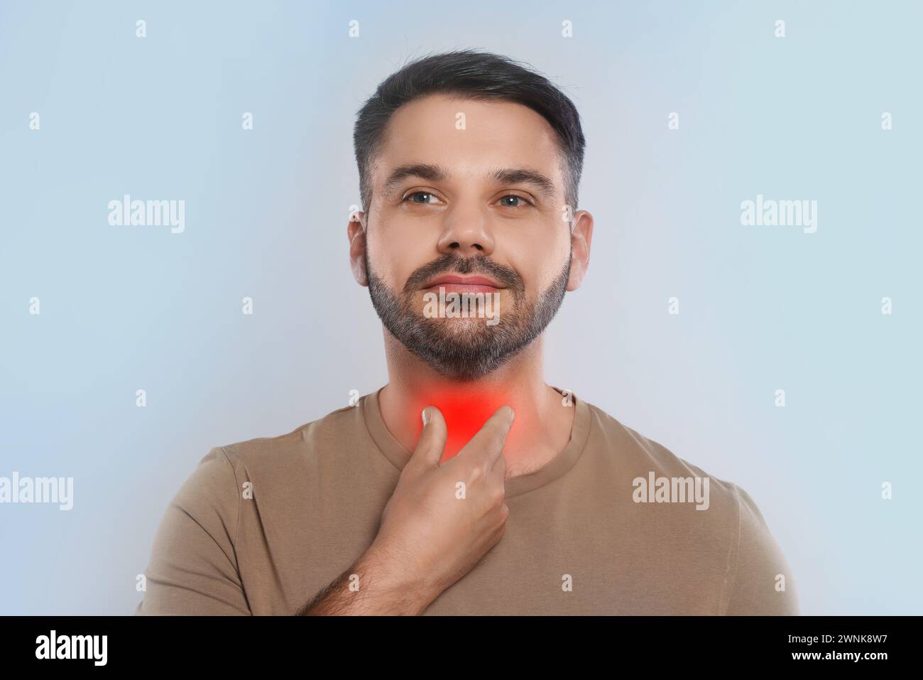 Endocrine system. Man doing thyroid self examination on light grey ...