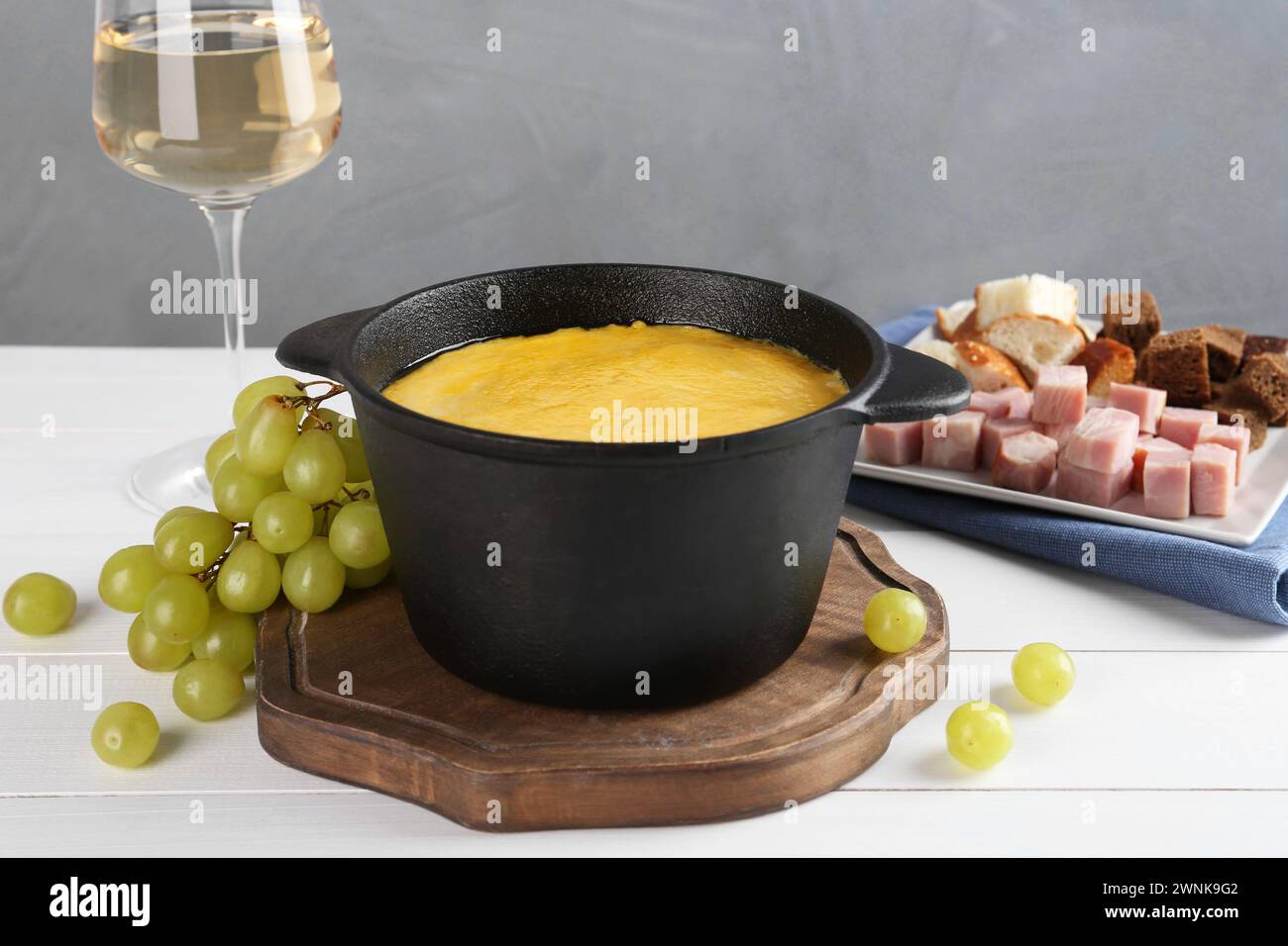 Fondue with tasty melted cheese, different products and aromatic wine ...