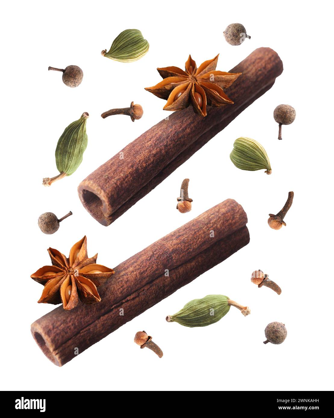 Cinnamon sticks and other aromatic spices falling on white background ...