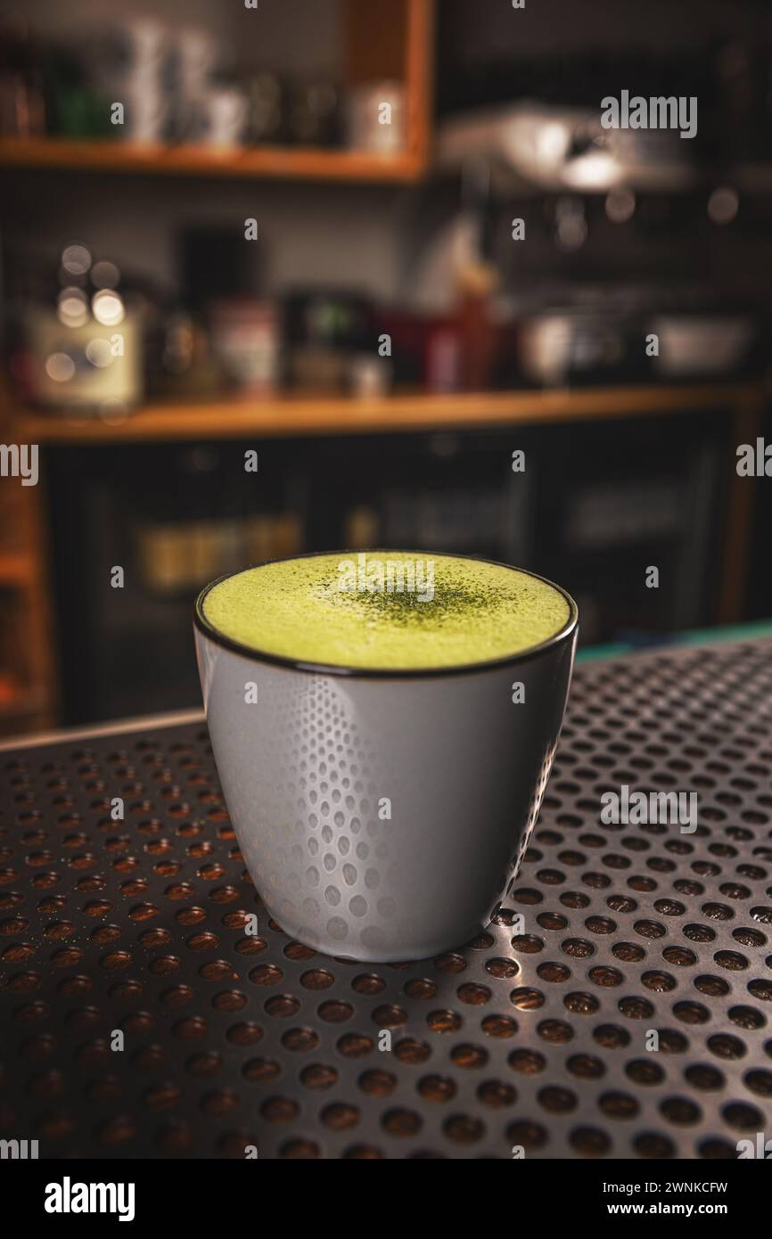 Cup of green tea matcha latte on bar counter Stock Photo - Alamy
