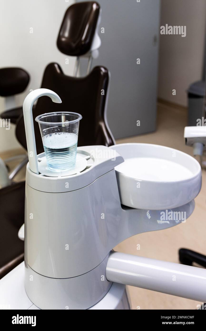 Disposable glass filled with CHX mouth rinse next to spiotoon bowl in ...