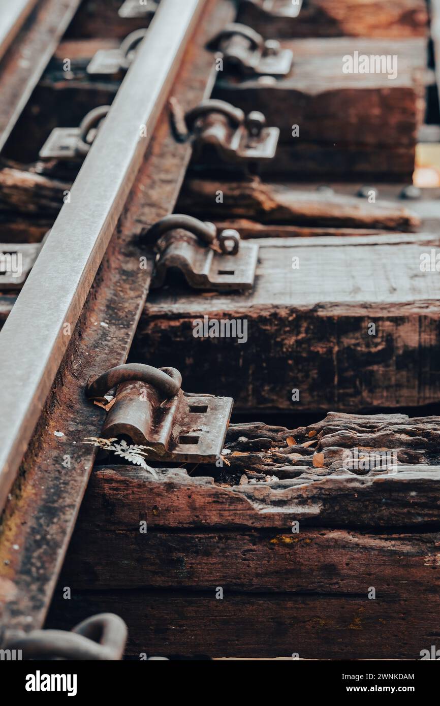 Close view of old railroad tracks dated 1902 with worn ties and gravel ...
