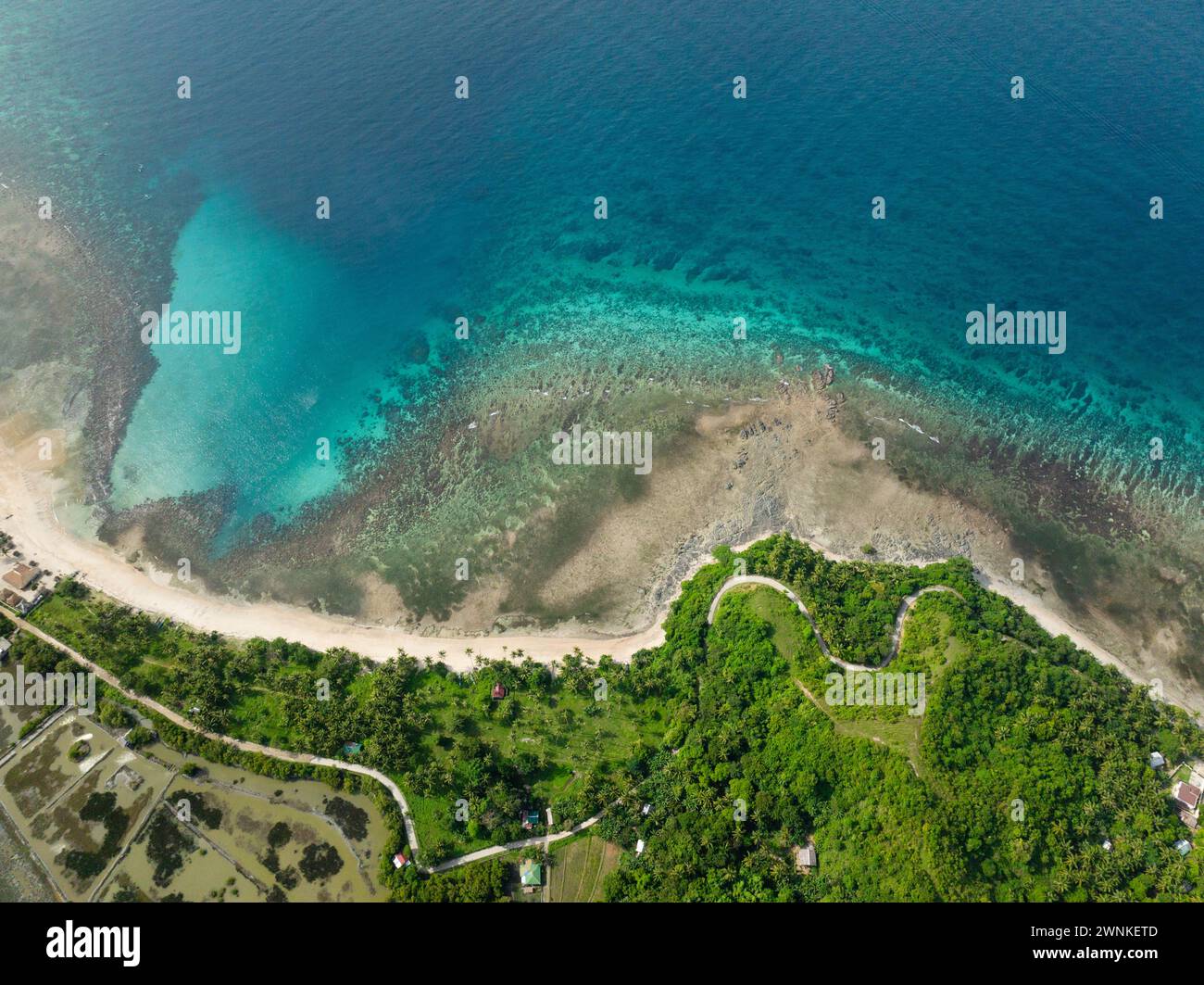 Beach resort with white sand and turquoise sea water and coral reefs ...