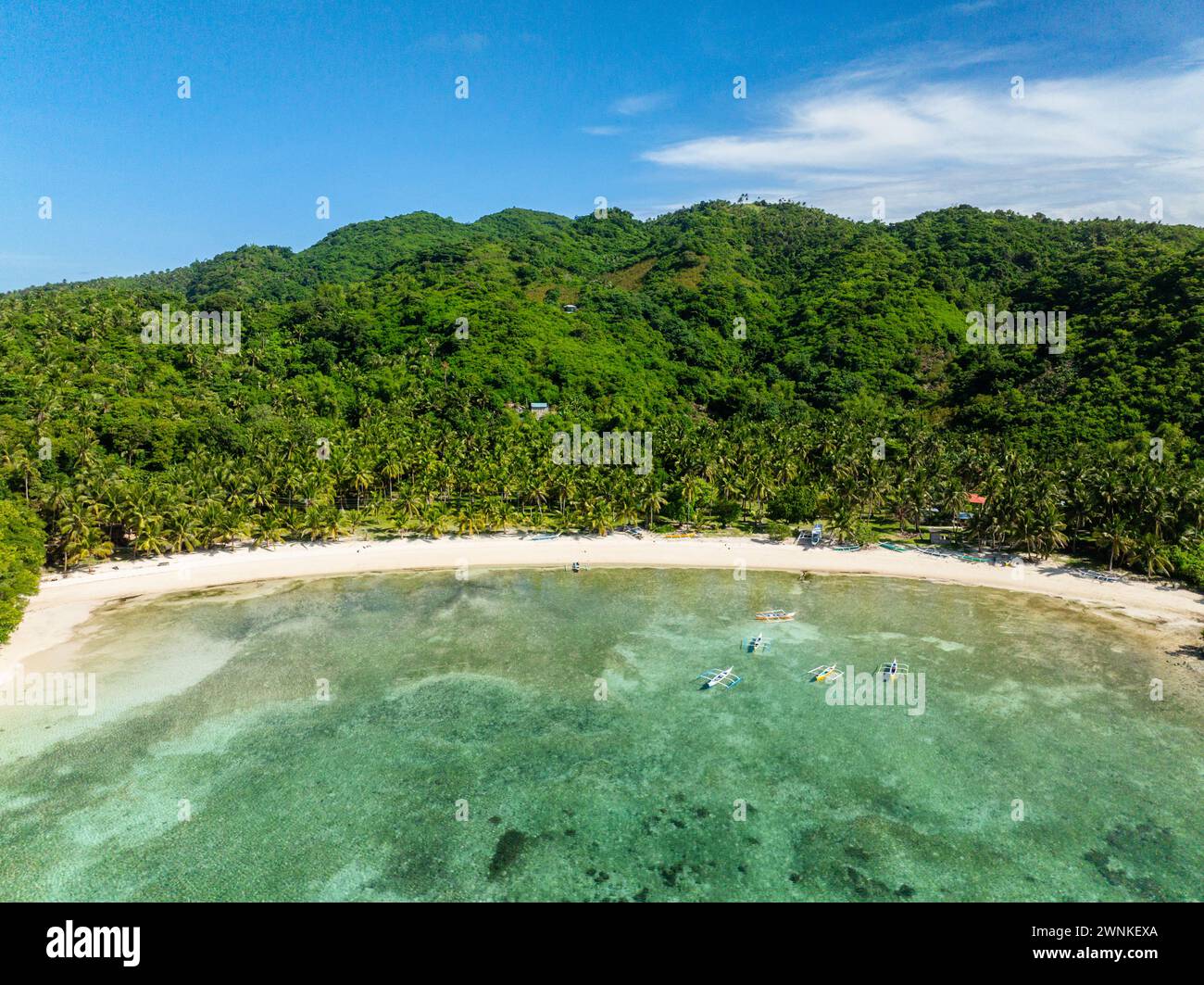 Cobrador Island with white sand beach and boat over turquoise clear ...