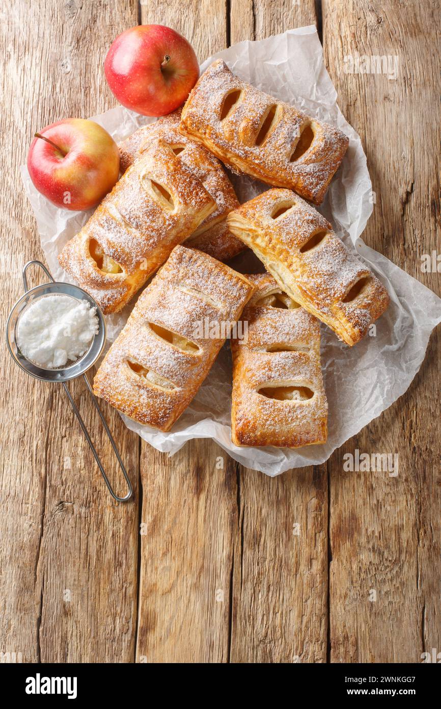 Homemade Puff pastry filled with apples close-up on a wooden table ...