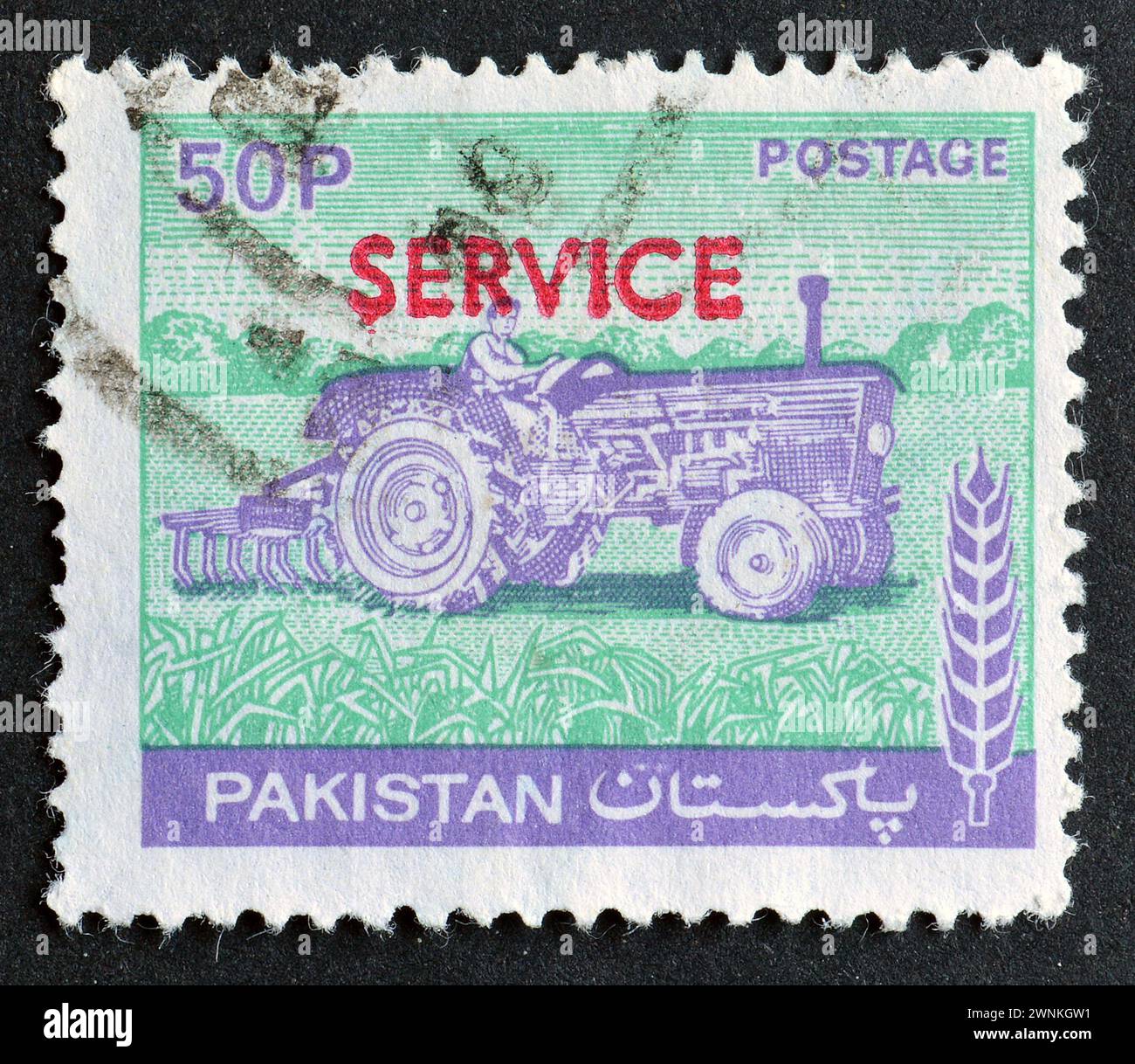 Cancelled postage stamp printed by Pakistan, that shows Woman Tractor ...