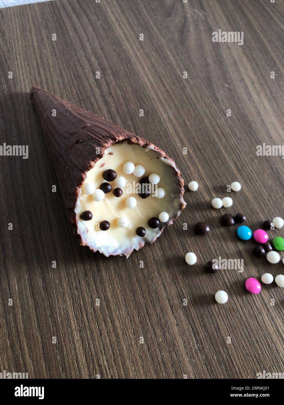 Dark chocolate truffle cone with white chocolate filling and hazelnut ...