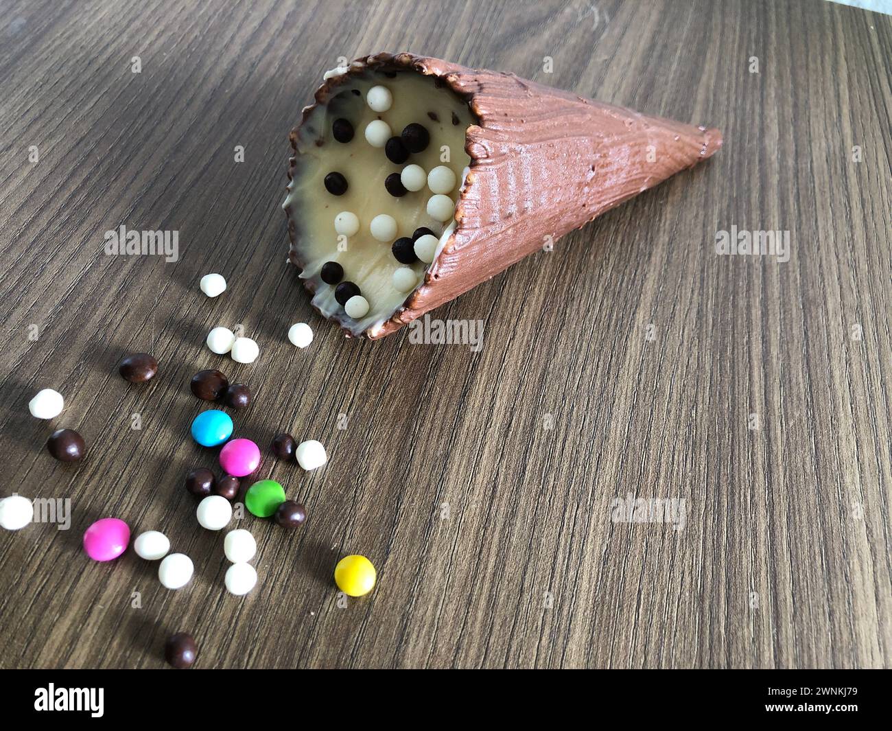 Dark chocolate truffle cone with white chocolate filling and hazelnut ...