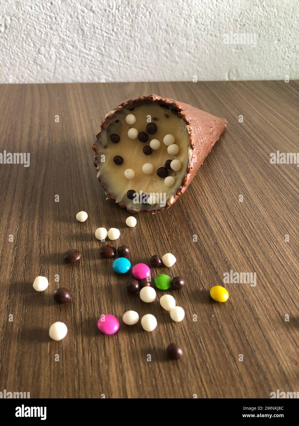 Dark chocolate truffle cone with white chocolate filling and hazelnut ...
