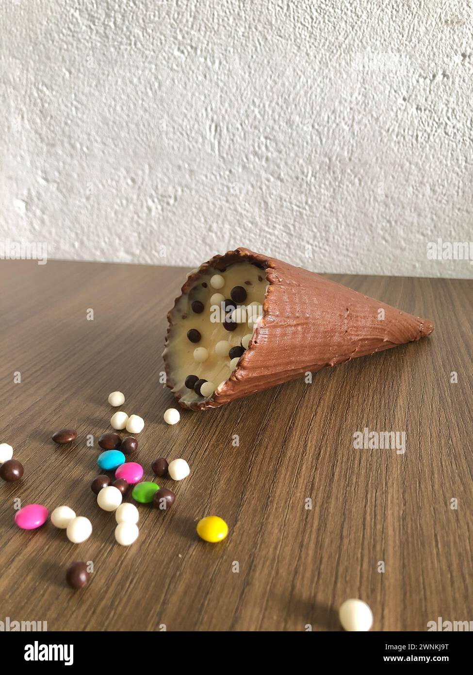 Dark chocolate truffle cone with white chocolate filling and hazelnut ...